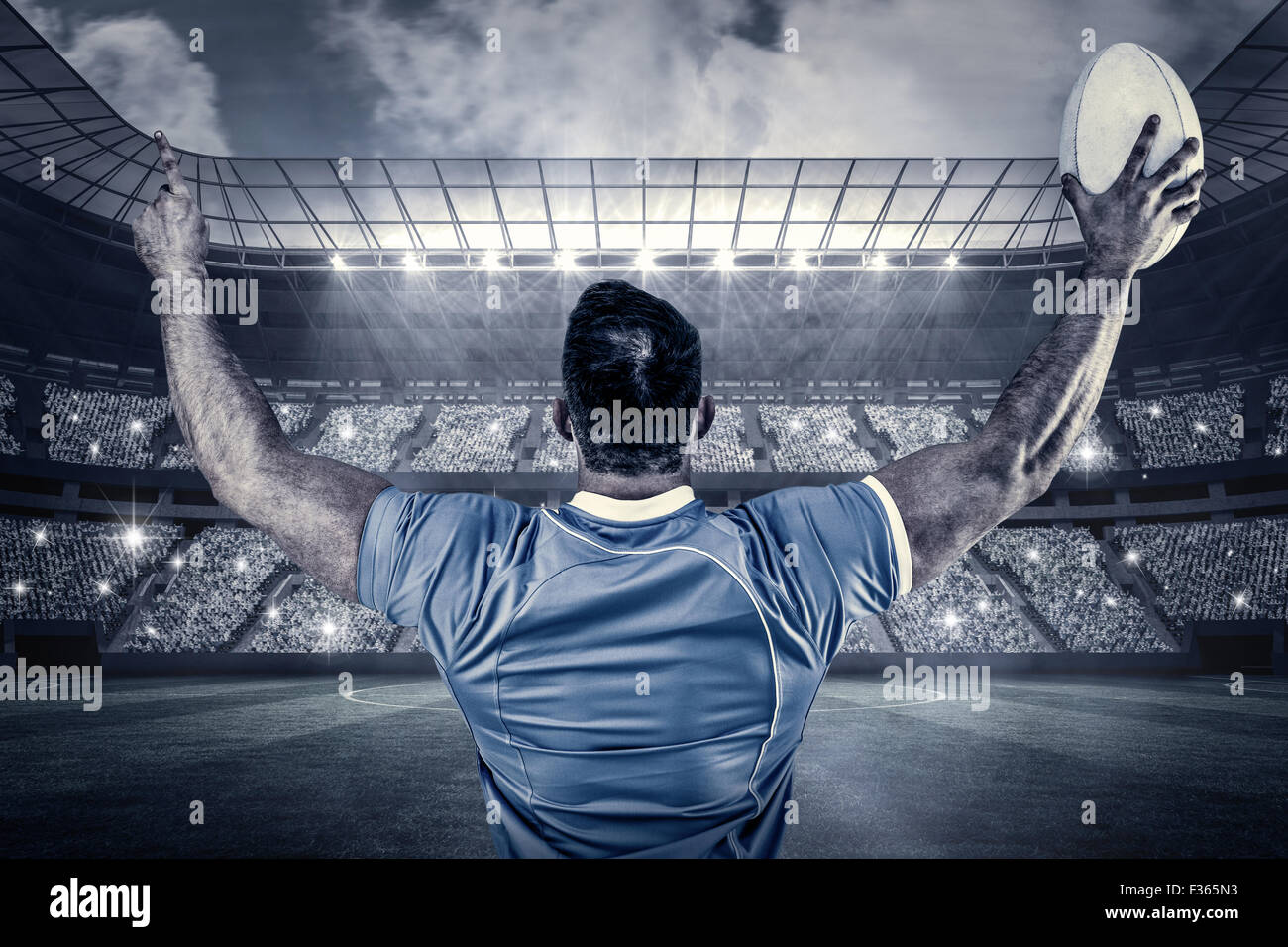 Composite image of rugby player cheering with the ball Stock Photo - Alamy