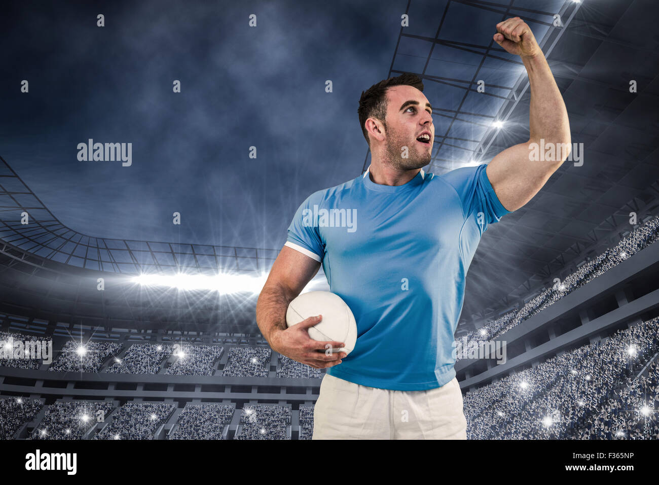 Composite image of rugby player cheering with the ball Stock Photo - Alamy