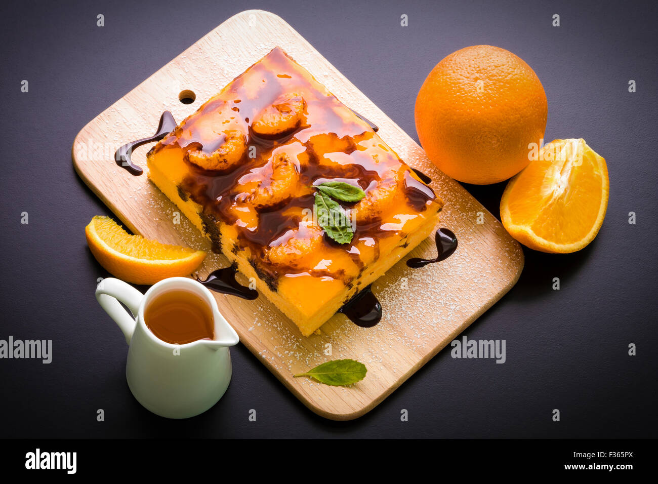 Orange cake with chocolate sauce for tea break Stock Photo - Alamy