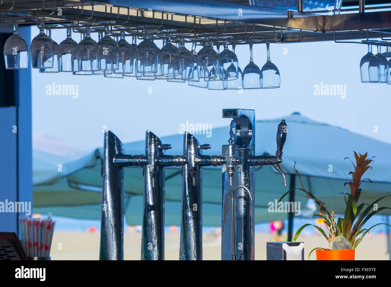 beer taps and crystal glasses in a beach bar Stock Photo - Alamy