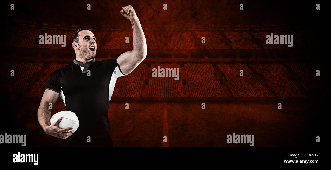 Composite image of rugby player cheering with the ball Stock Photo - Alamy