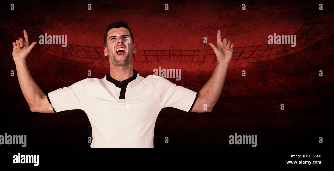 Composite image of excited rugby player pointing up Stock Photo - Alamy