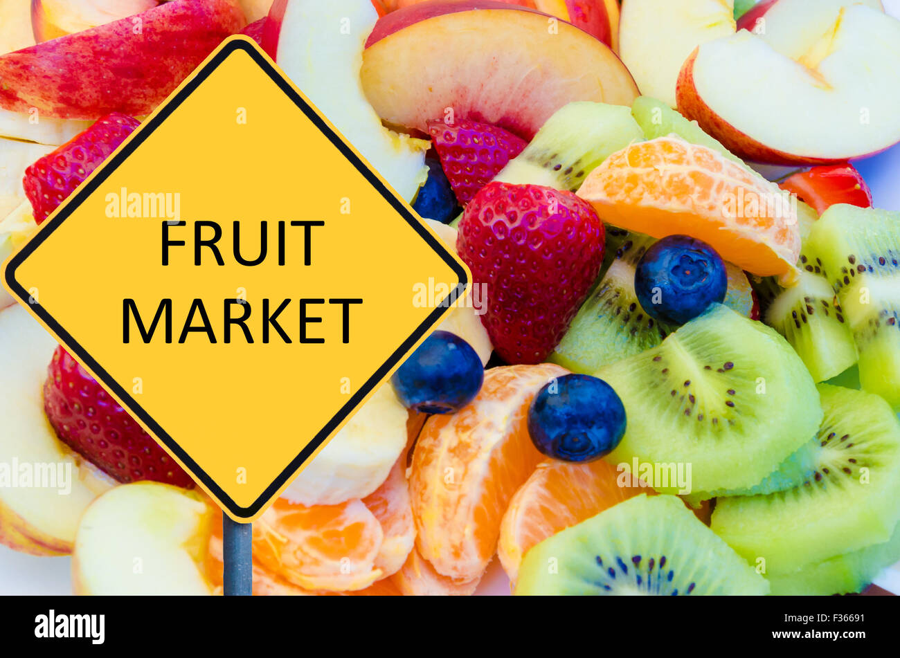 Yellow roadsign with message FRUIT MARKET over background of healthy ...