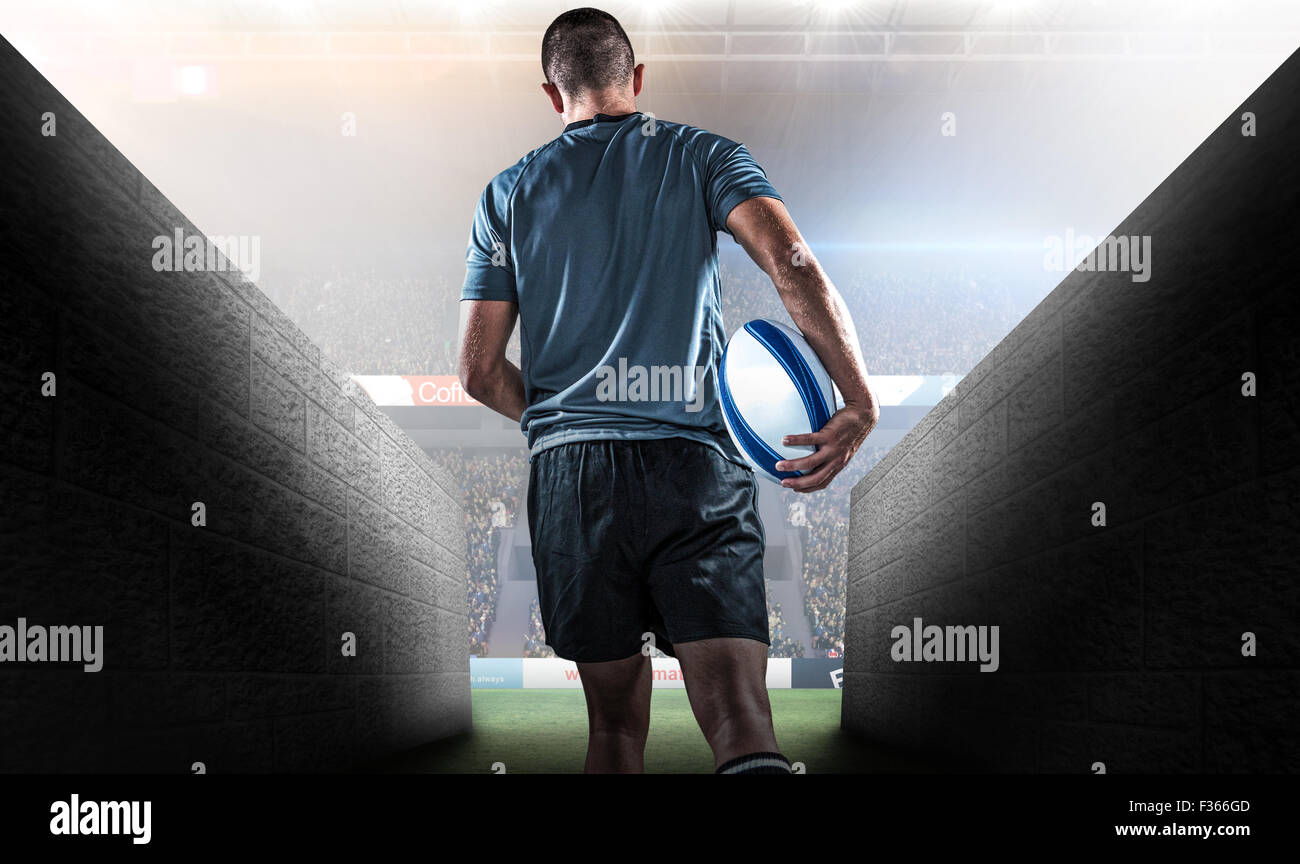 Composite image of rear view of rugby player running with ball Stock ...