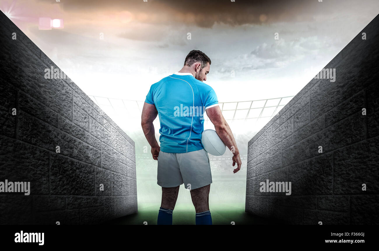 Composite image of rugby player standing with ball Stock Photo - Alamy