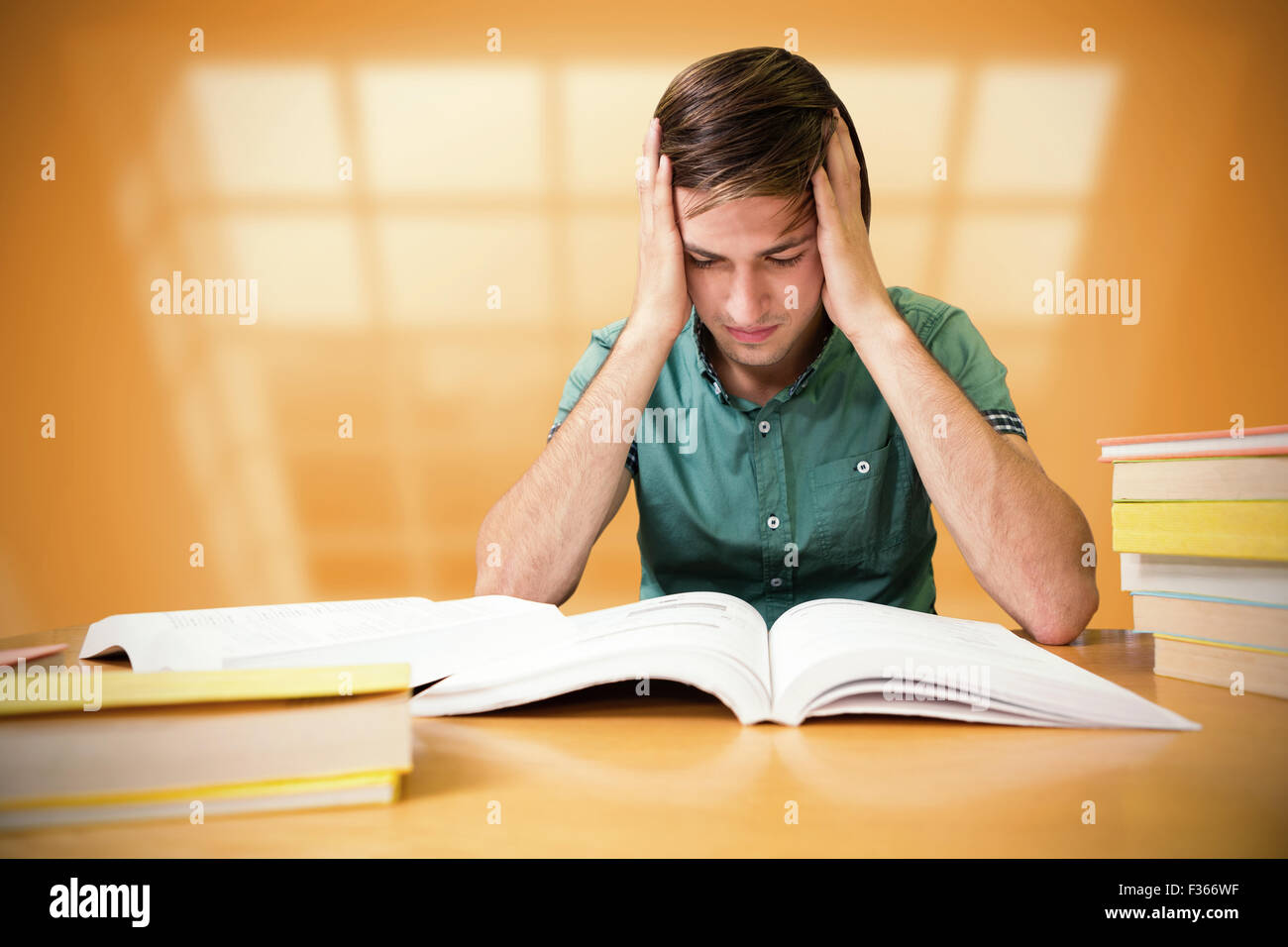 Composite image of student sitting in library reading Stock Photo - Alamy