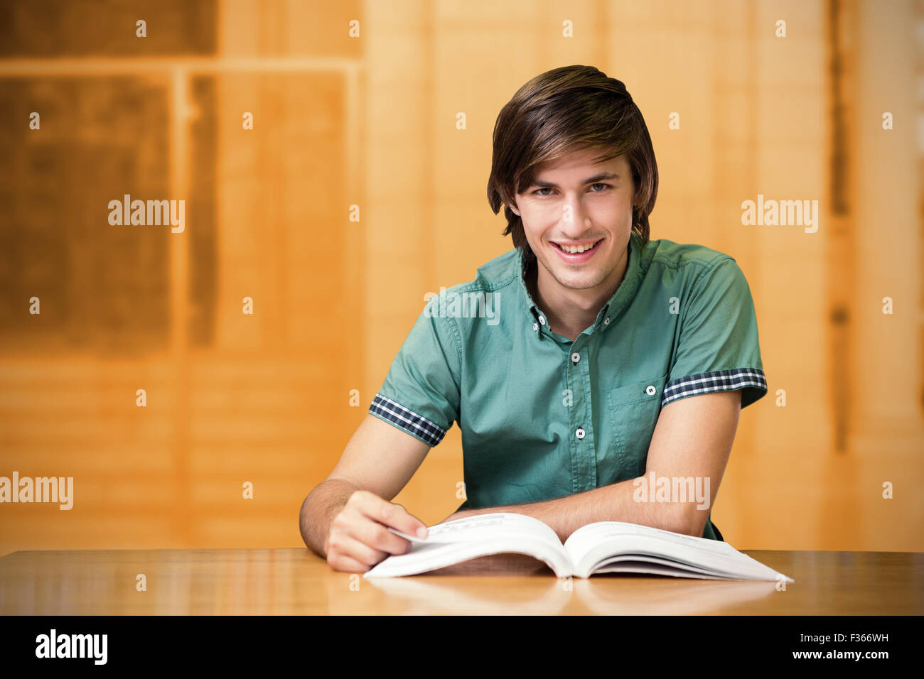 Composite image of student sitting in library reading Stock Photo - Alamy