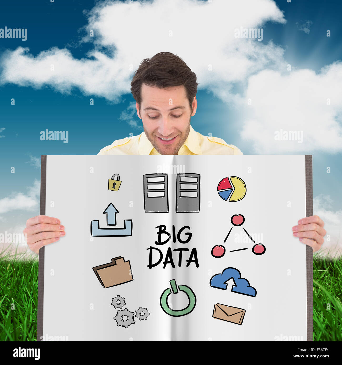 Composite image of man showing a book Stock Photo - Alamy