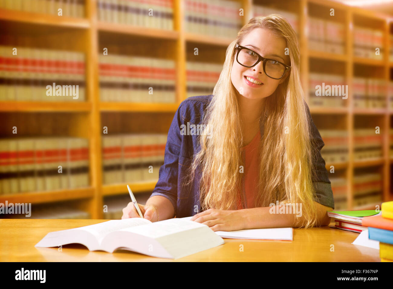Composite image of student studying in the library Stock Photo - Alamy