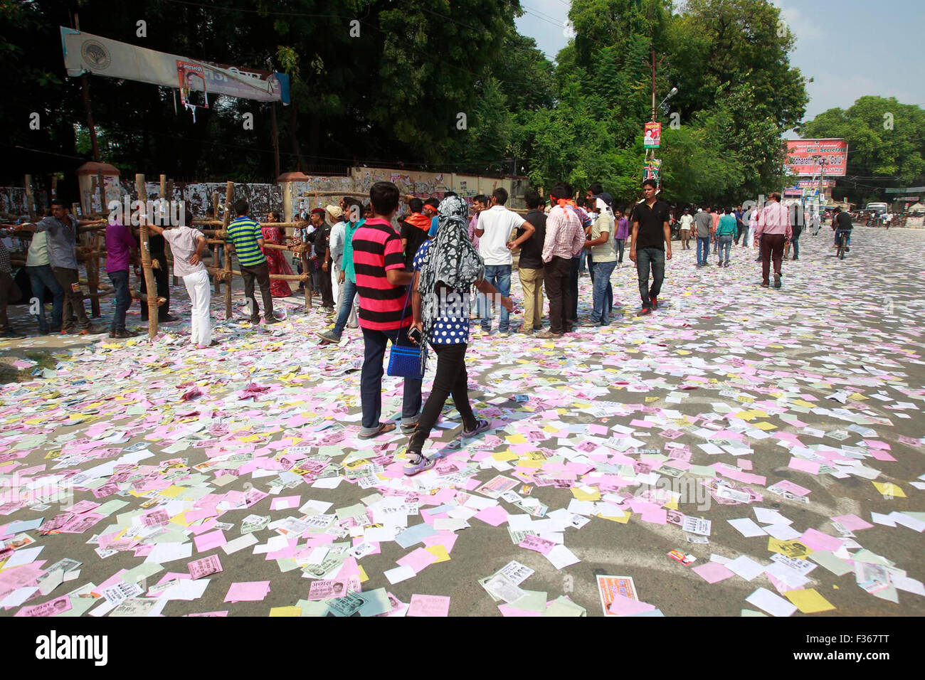 Allahabad, India. 30th Sep, 2015. Students walk on the paper handbills ...