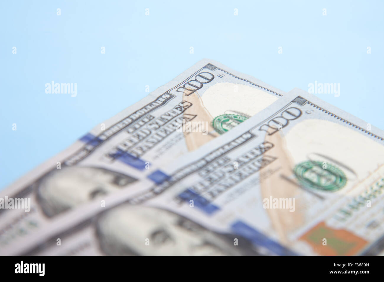 Two hundred dollar notes. All on blue background Stock Photo - Alamy