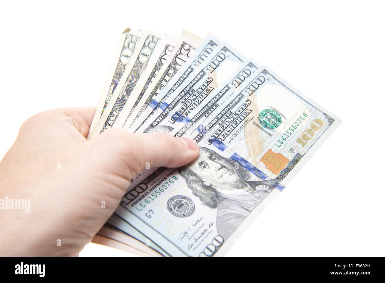 Hand holding various dollar notes. All on white background Stock Photo ...