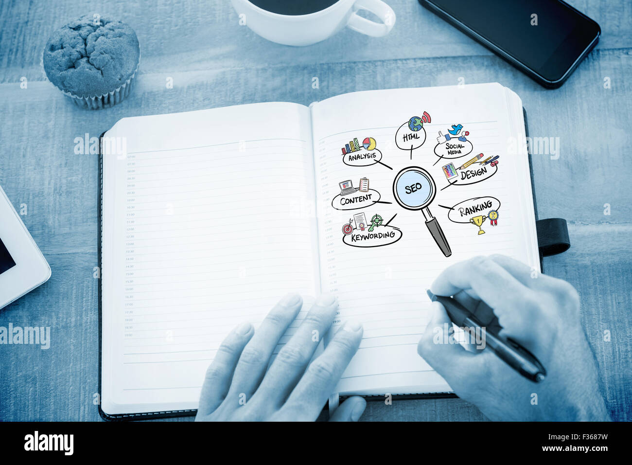 Composite image of man writing notes on diary Stock Photo - Alamy