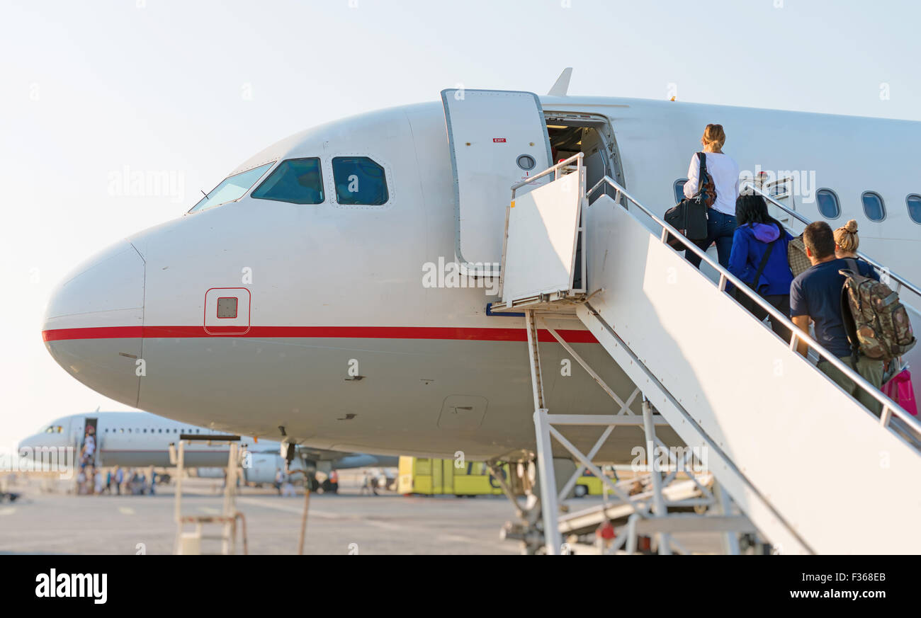 Airplane Boarding. Passengers climb the ladder Stock Photo - Alamy