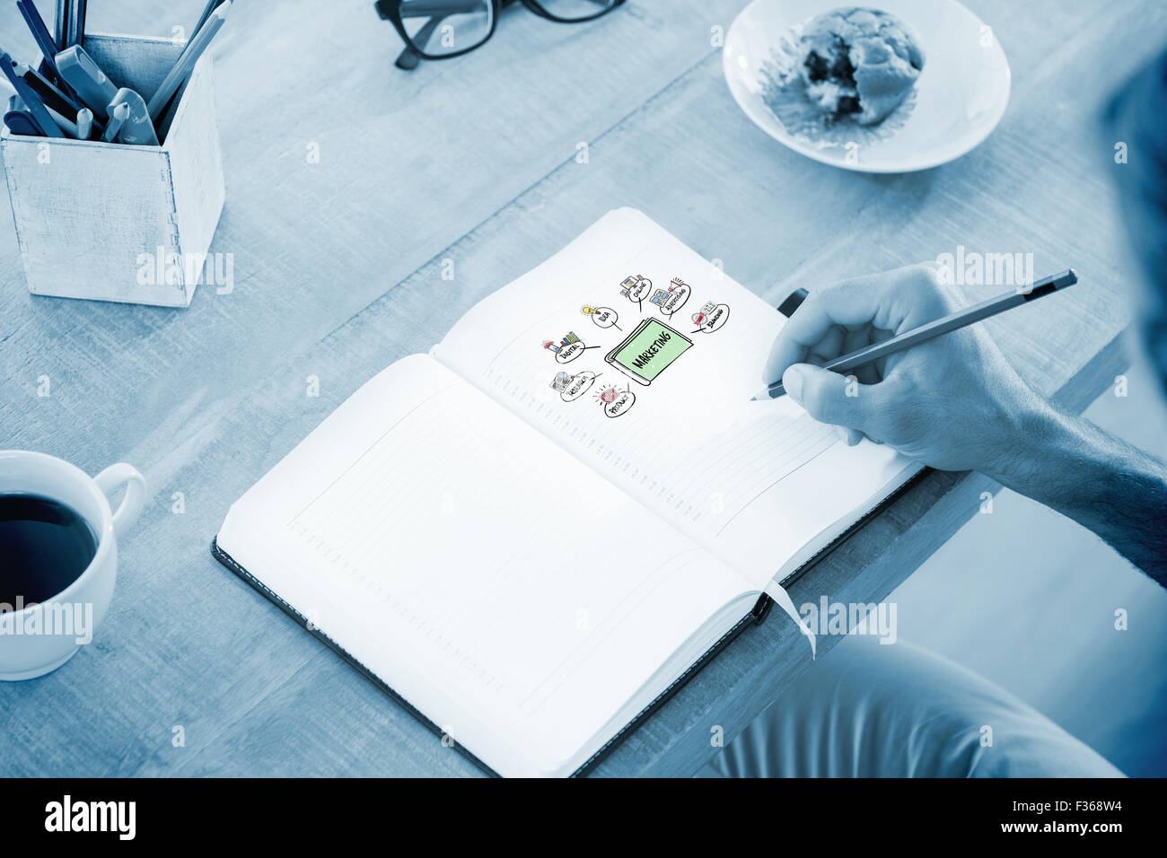 Composite image of man writing notes on diary Stock Photo - Alamy