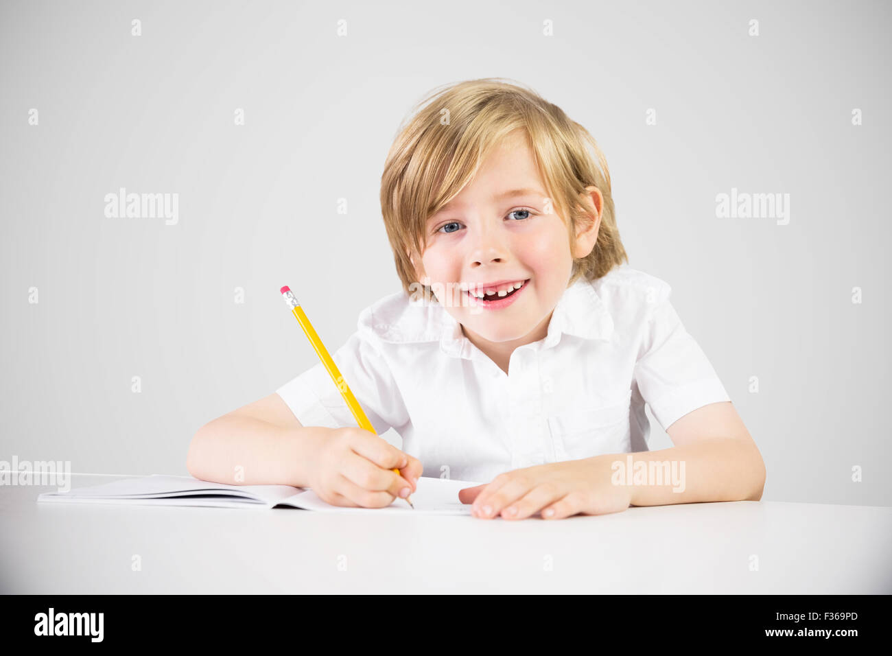 Composite image of cute pupil writing Stock Photo - Alamy