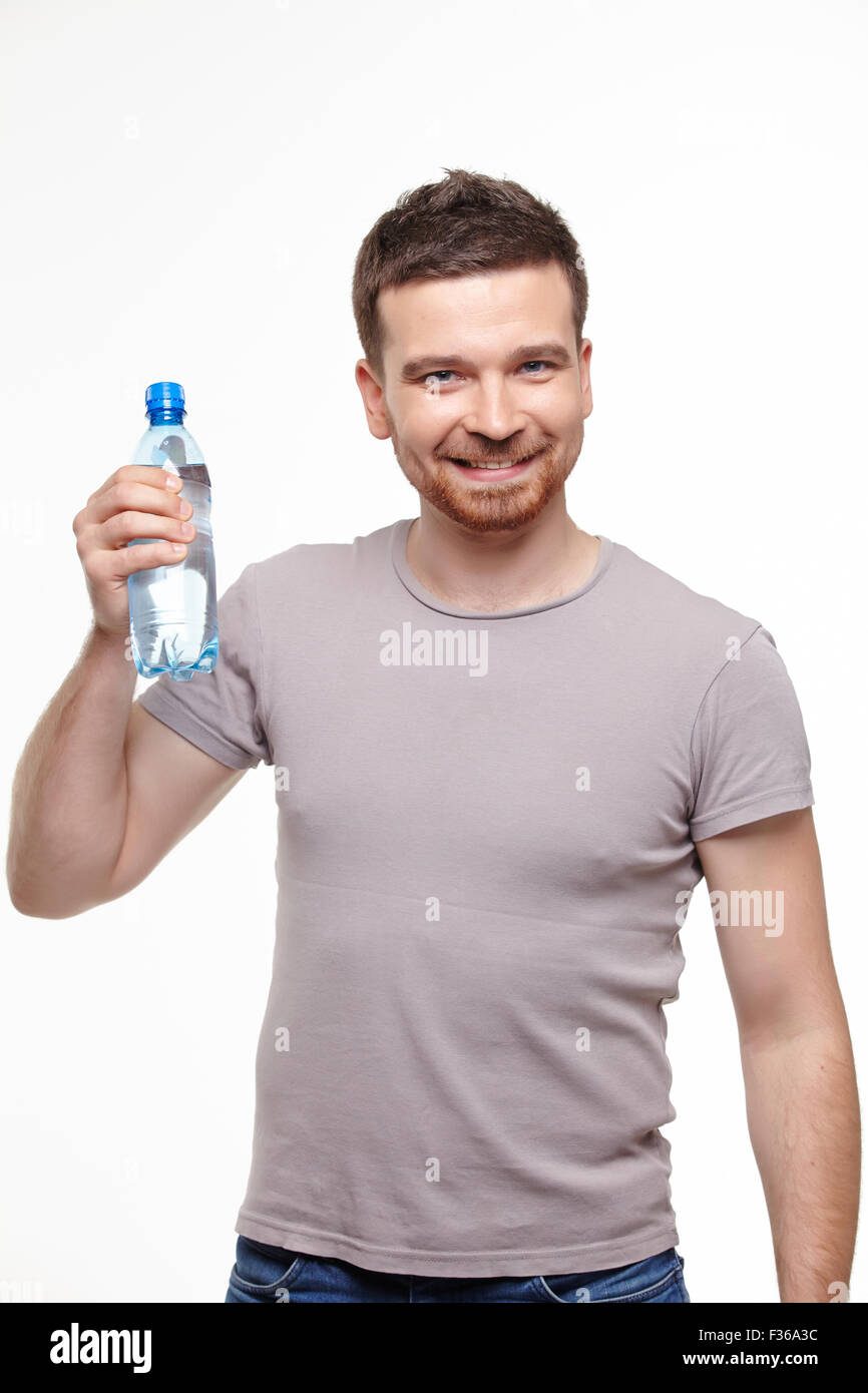 smiling young man showing water bottle Stock Photo - Alamy