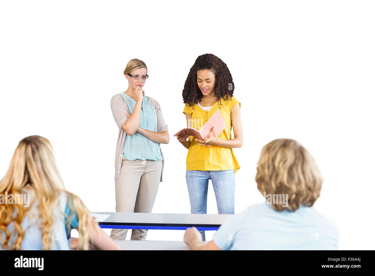 Student explaining notes besides teacher in class Stock Photo - Alamy