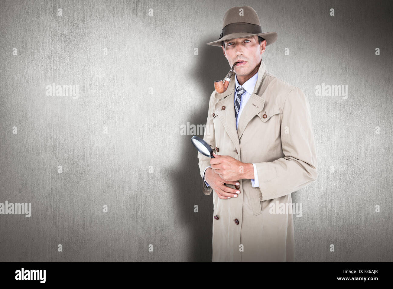 Composite image of spy looking through magnifier Stock Photo - Alamy