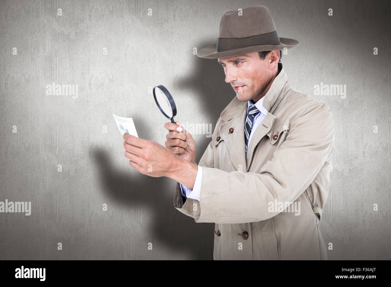 Composite image of spy looking through magnifier Stock Photo - Alamy