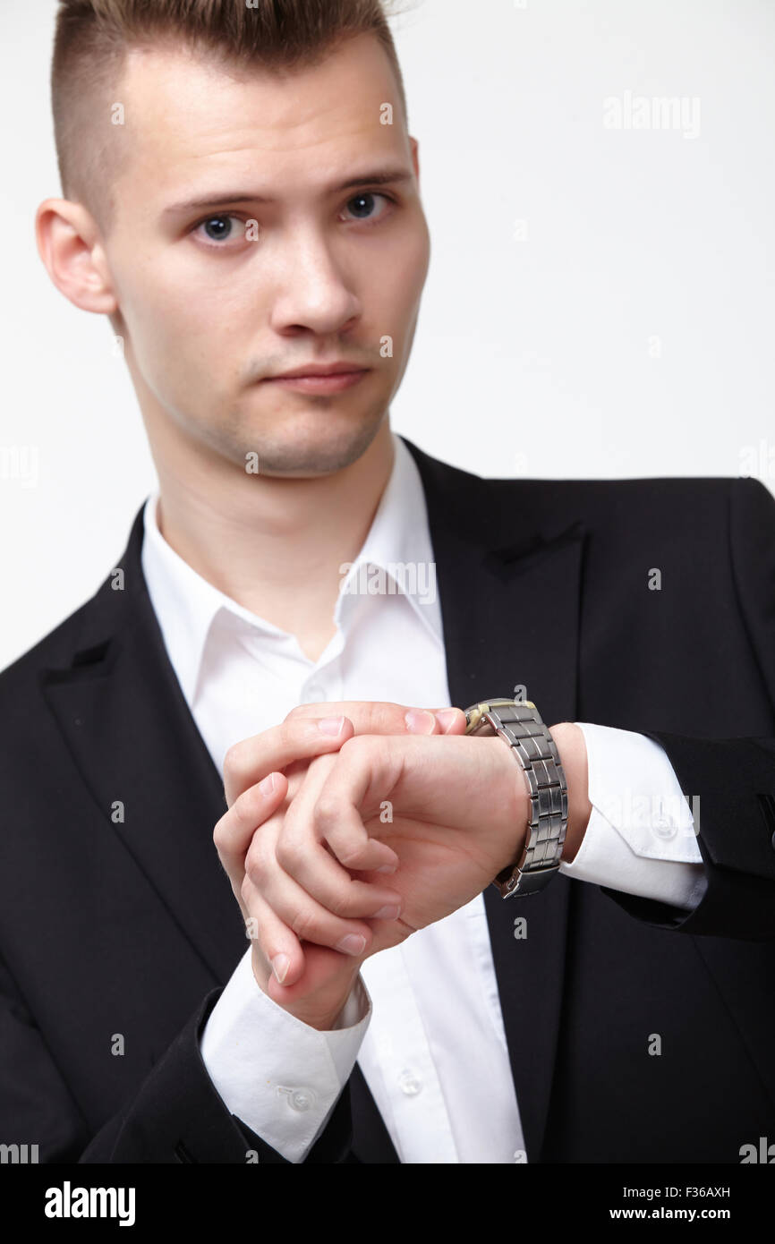 businessman in a suit looking at his watch Stock Photo - Alamy