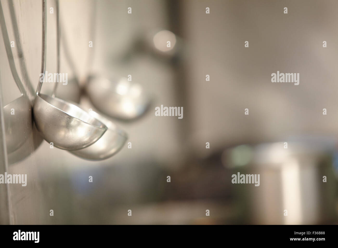 ladles hanging in the kitchen Stock Photo - Alamy