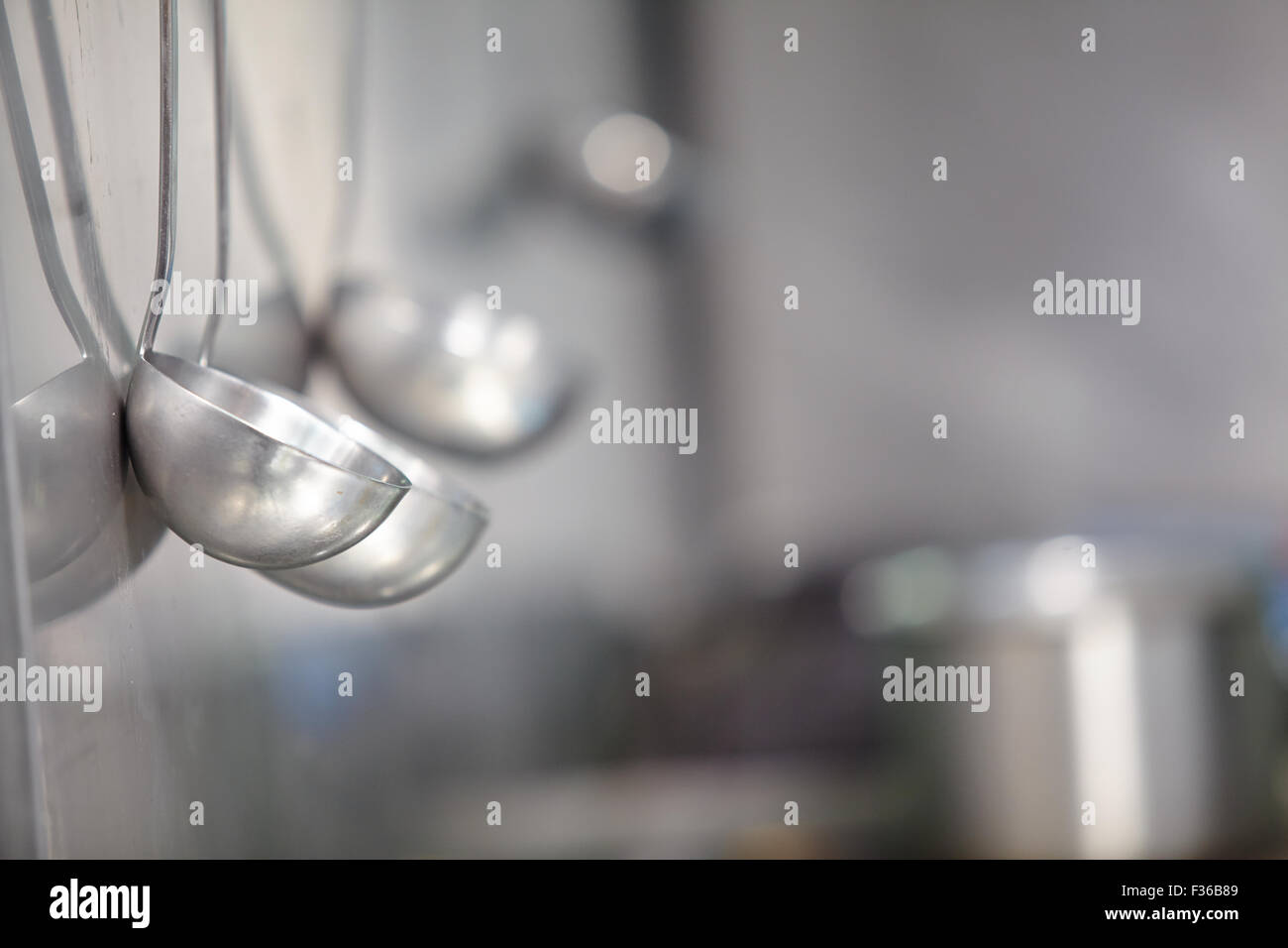 ladles hanging in the kitchen Stock Photo - Alamy