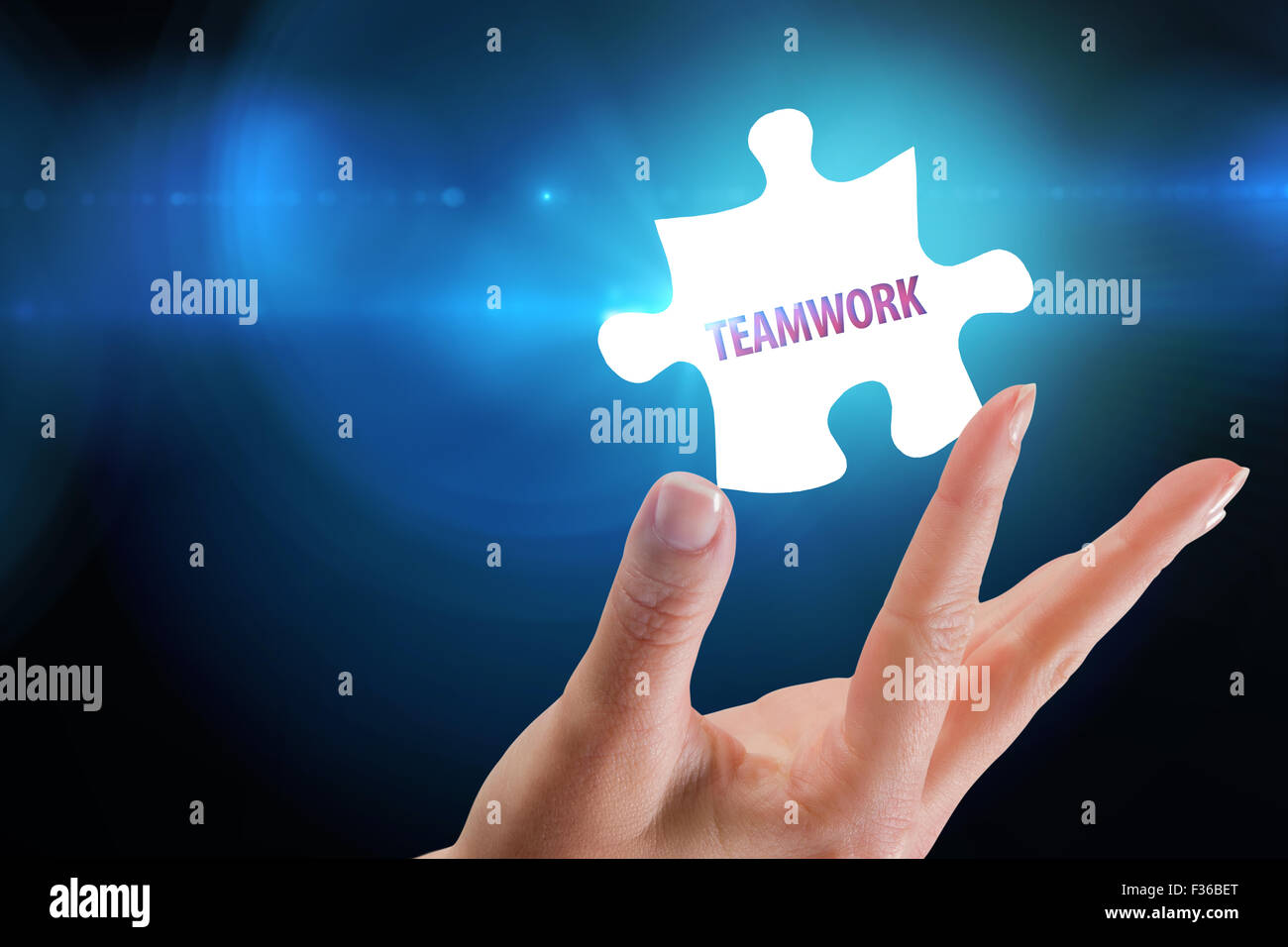 Teamwork against blue background with vignette Stock Photo - Alamy