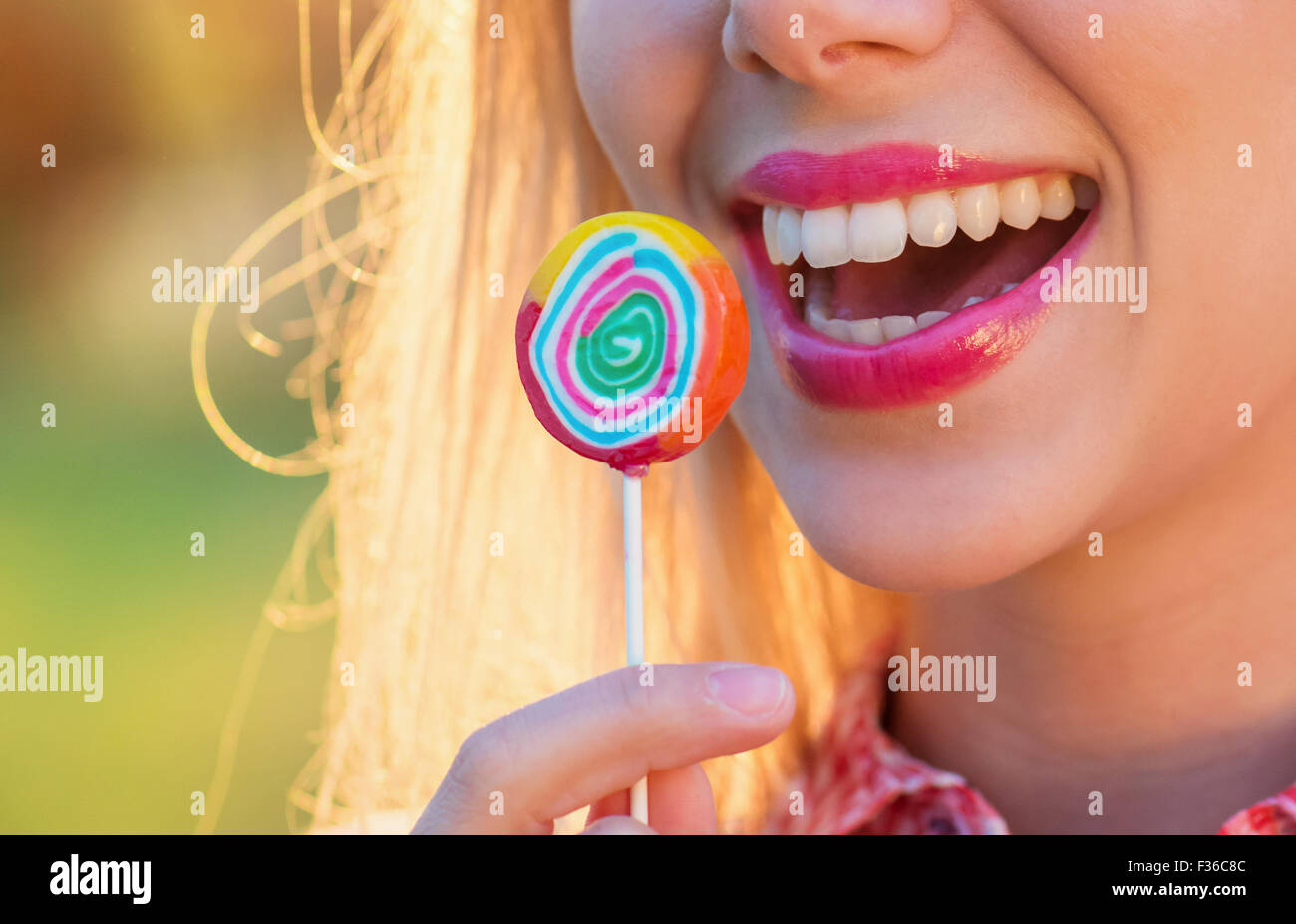 Beautiful woman with lollipop Stock Photo - Alamy