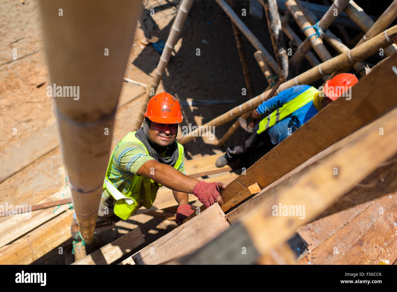 An Ecuadorian shipbuilder works on a traditional wooden fishing vessel ...