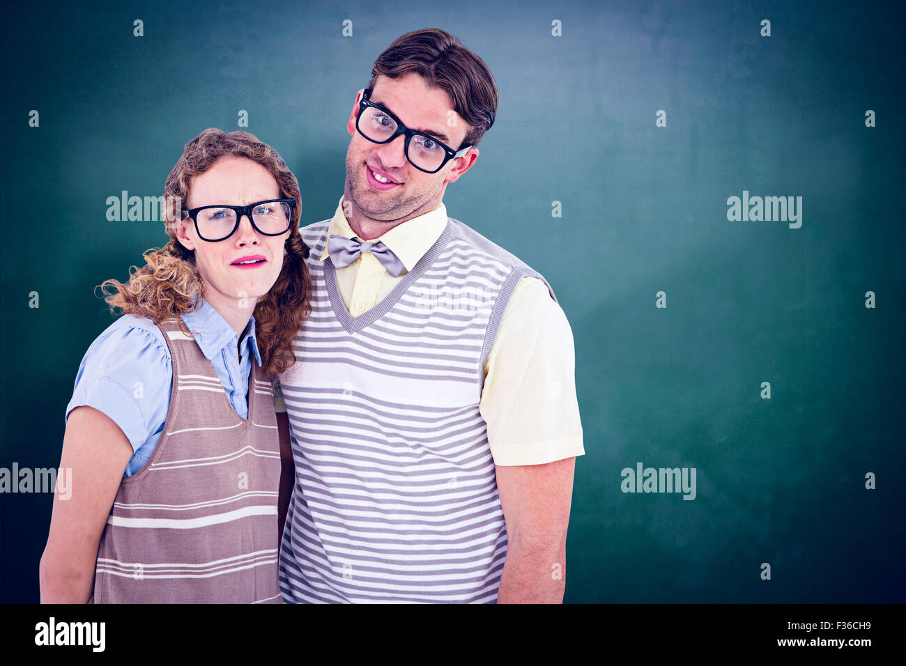 Composite image of happy geeky hipster couple with silly faces Stock ...