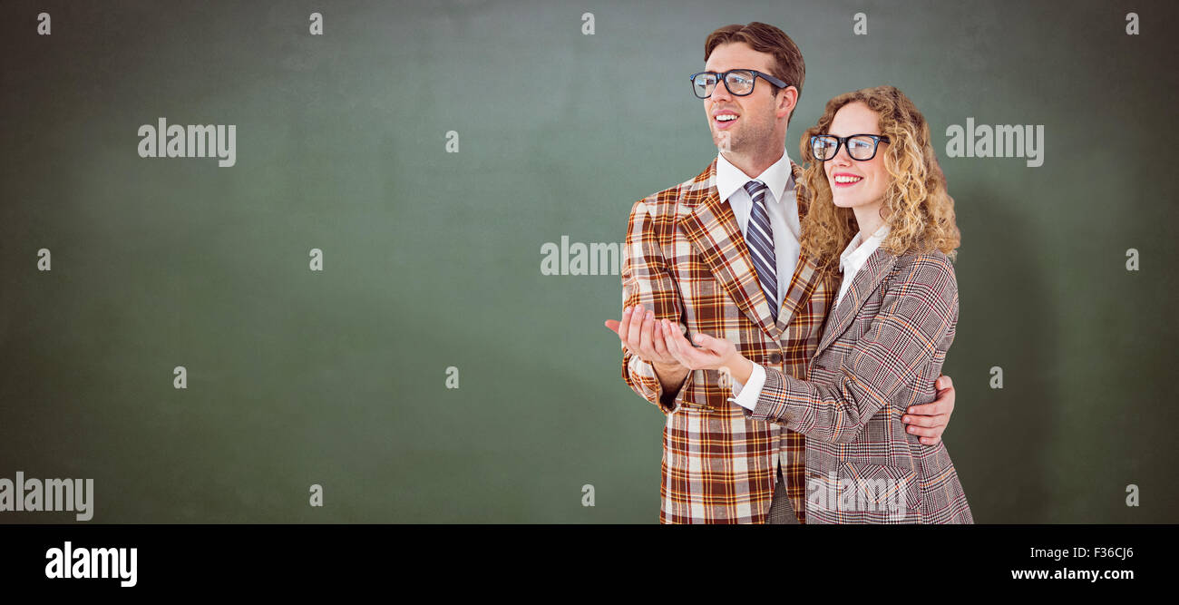 Composite image of geeky young hipster smiling at camera Stock Photo - Alamy