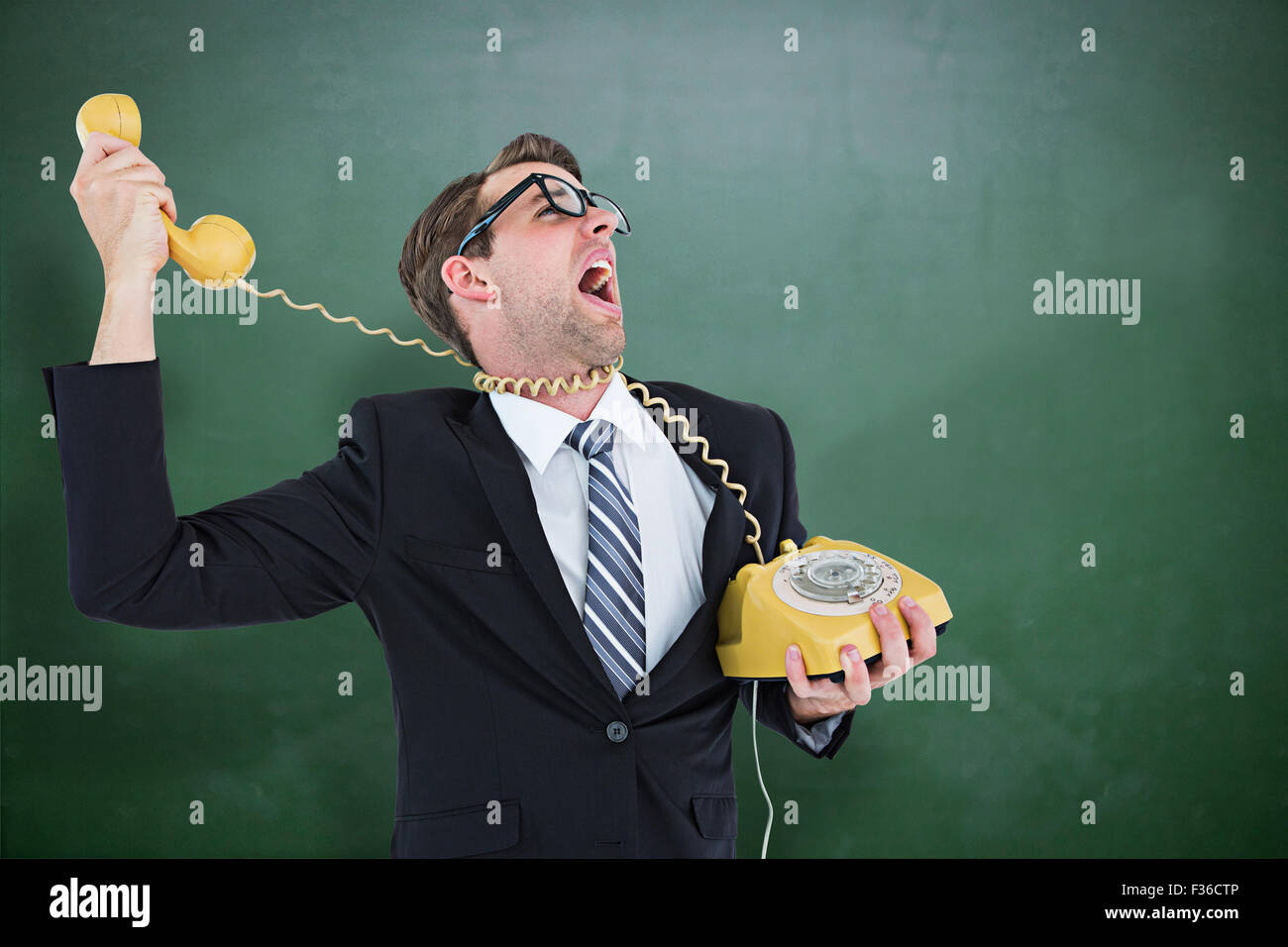 Composite image of geeky businessman being strangled by phone cord ...
