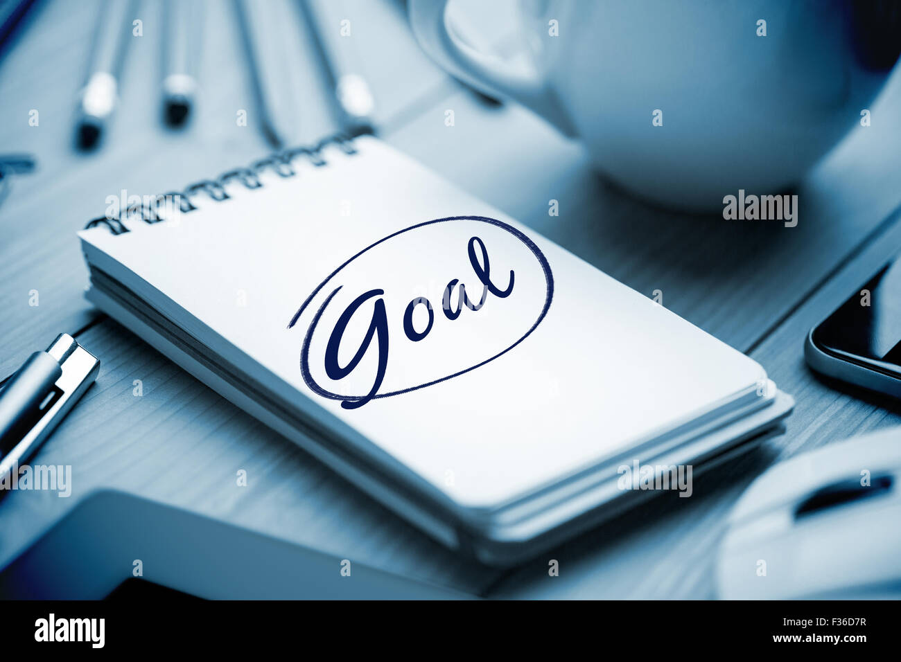 Goal against notepad on desk Stock Photo - Alamy