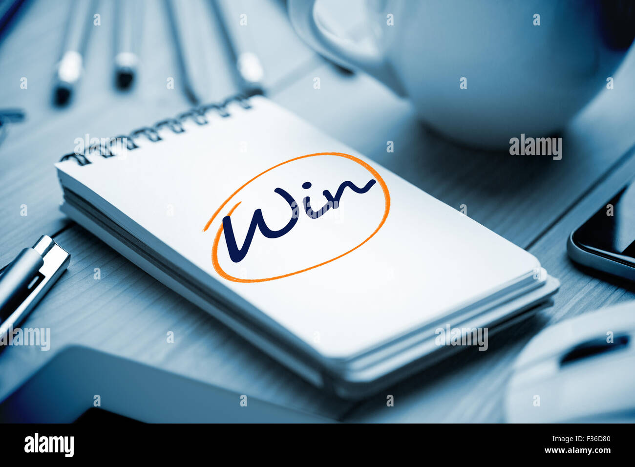 Win against notepad on desk Stock Photo - Alamy
