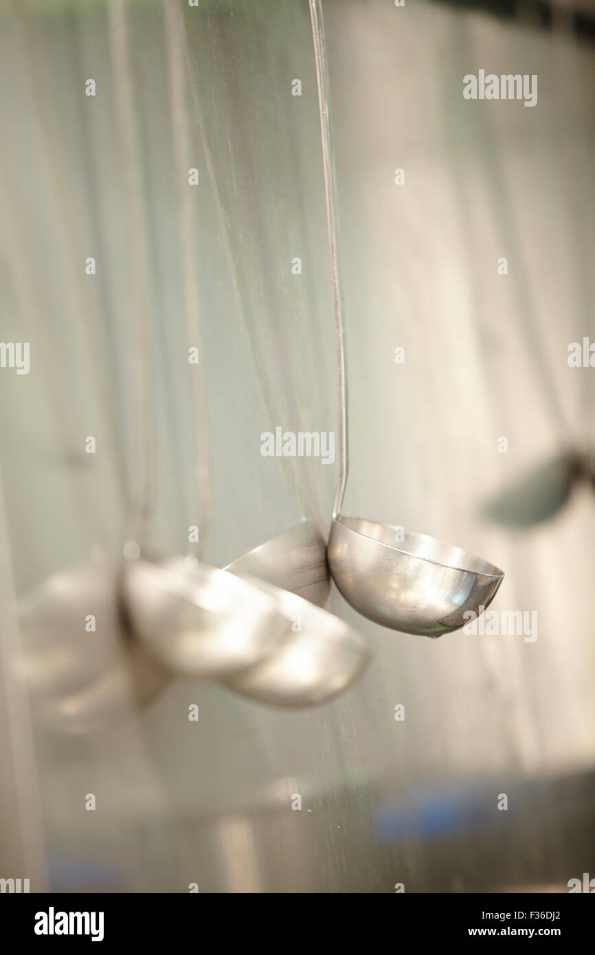 ladles hanging in the kitchen Stock Photo - Alamy