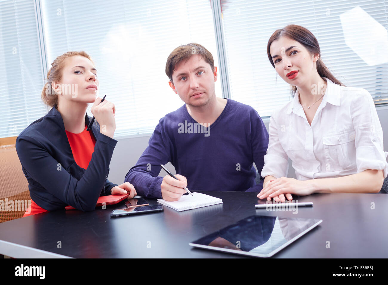 Three businessmen discussing something together Stock Photo - Alamy