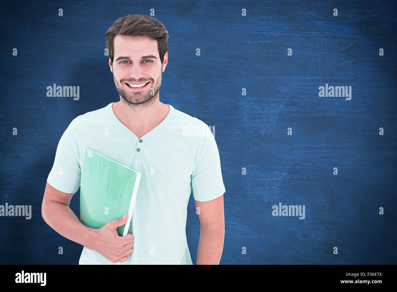 Composite image of student holding notepad Stock Photo - Alamy