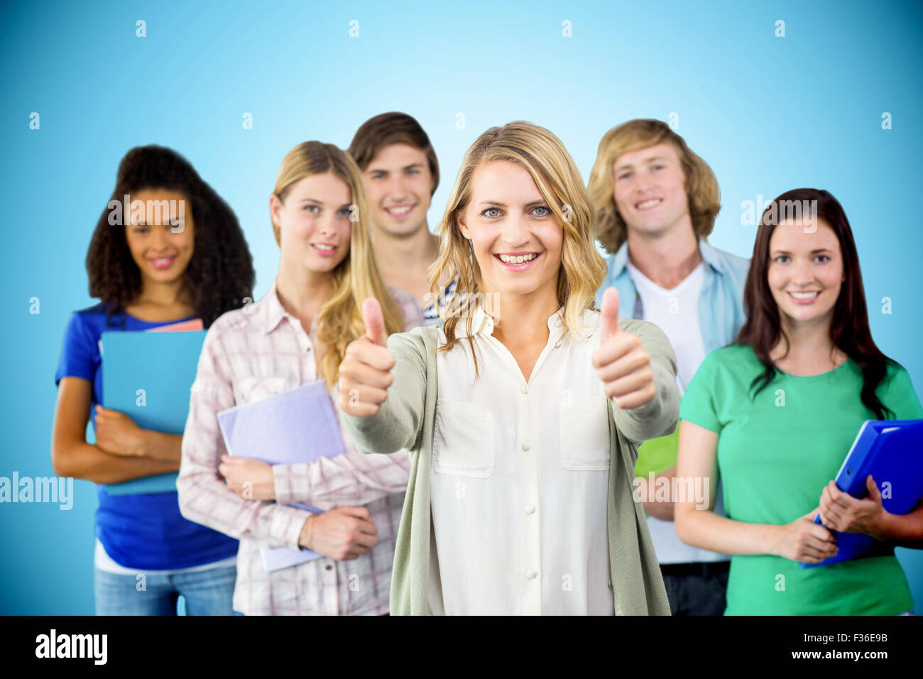 Happy students gesturing thumbs up hi-res stock photography and images ...