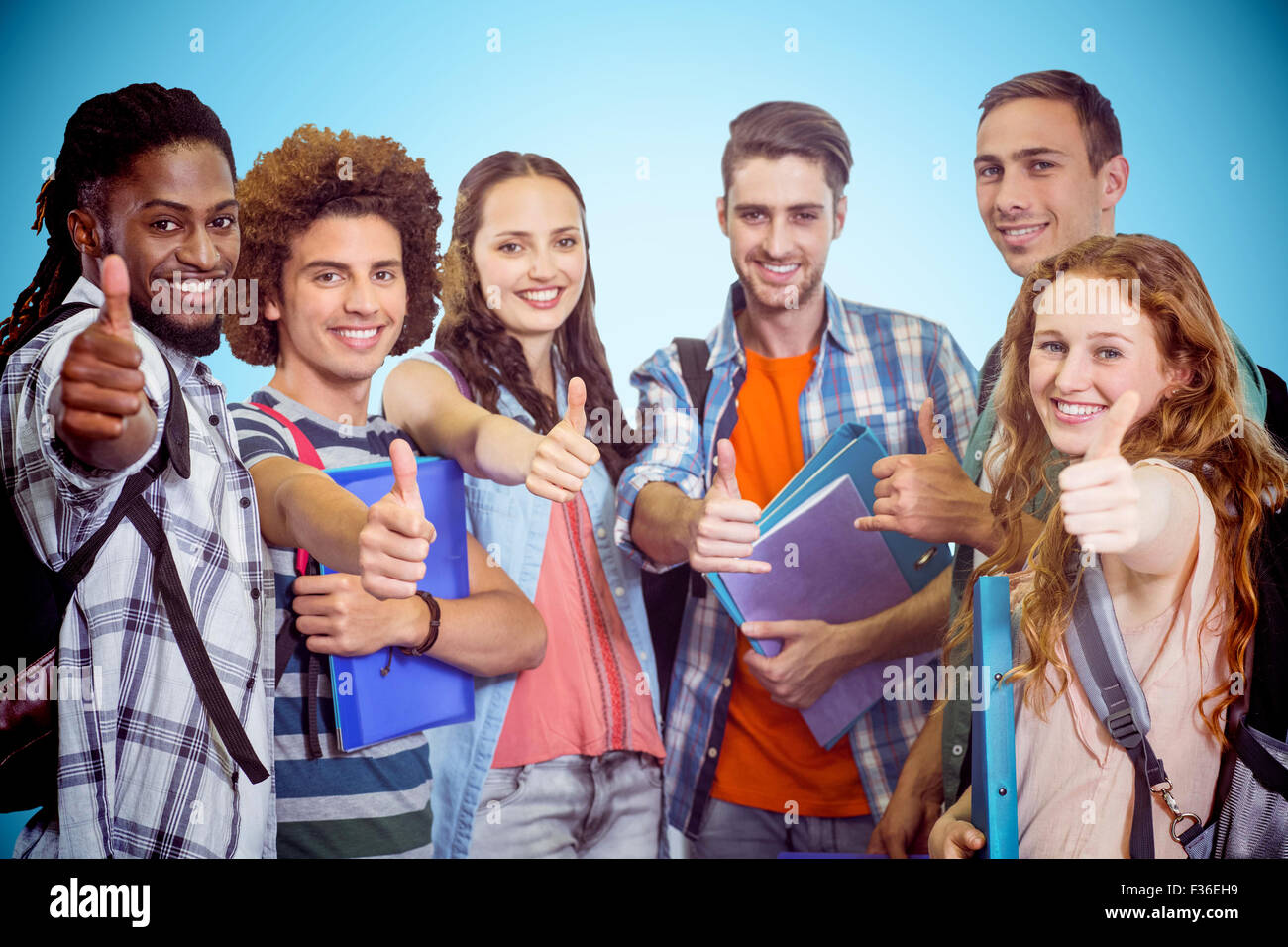 Composite image of smiling group of students doing thumbs up Stock ...