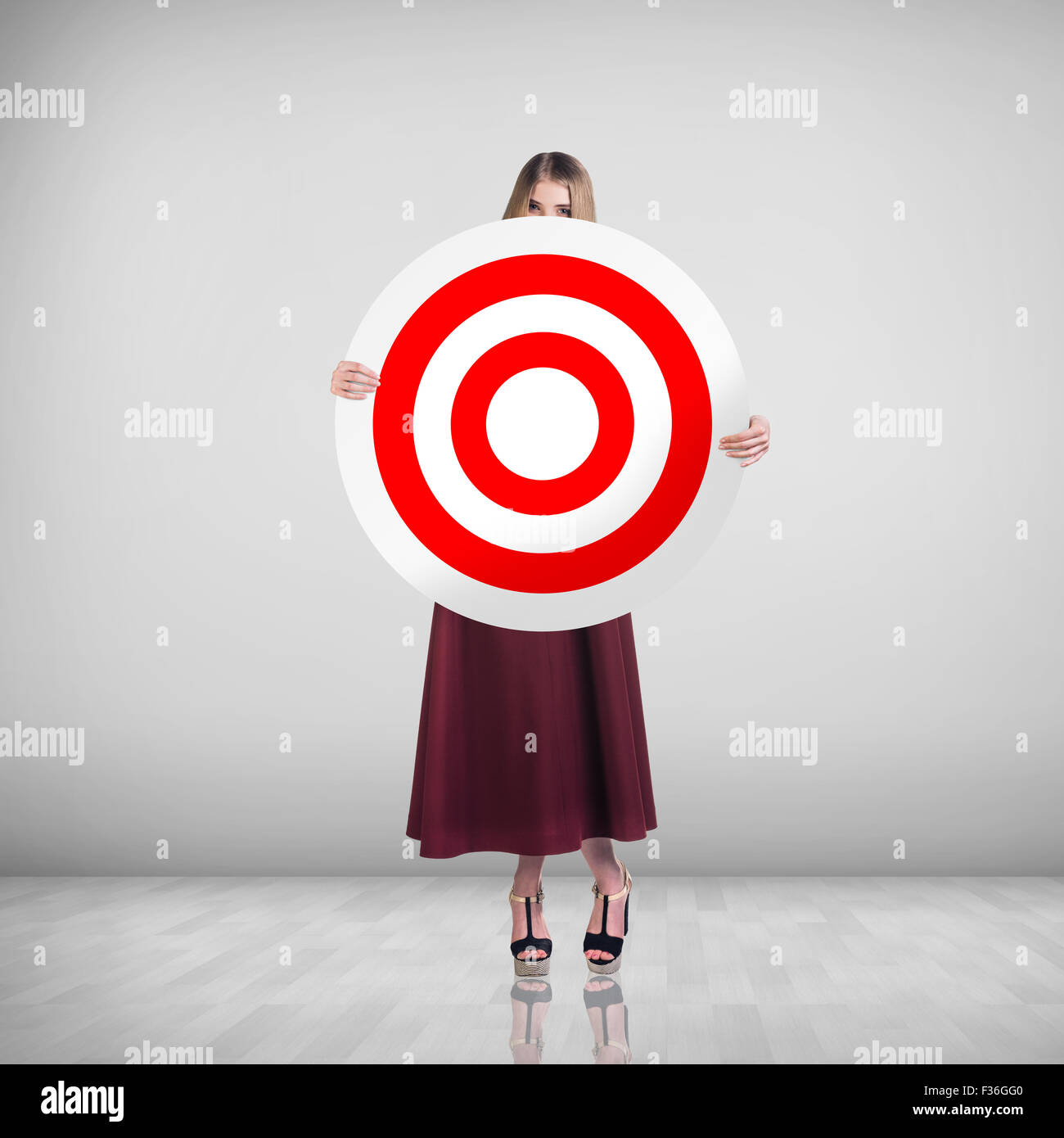 Business woman holding big target Stock Photo - Alamy