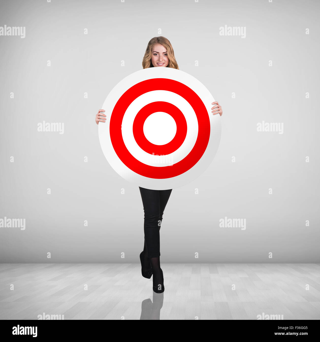 Business woman holding big target Stock Photo - Alamy