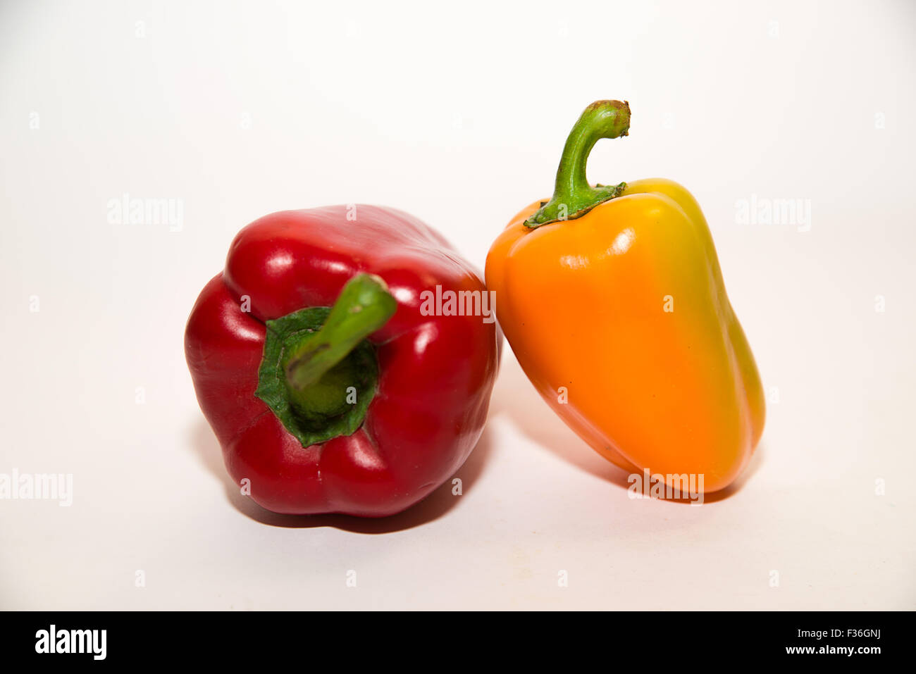 Two peppers on a white background Stock Photo - Alamy