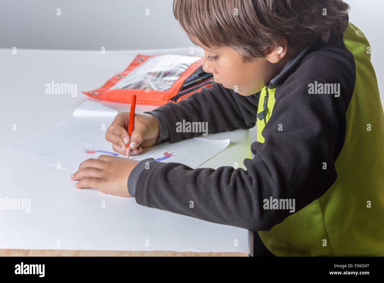 Young boy drawing picture for homeschool project Stock Photo - Alamy