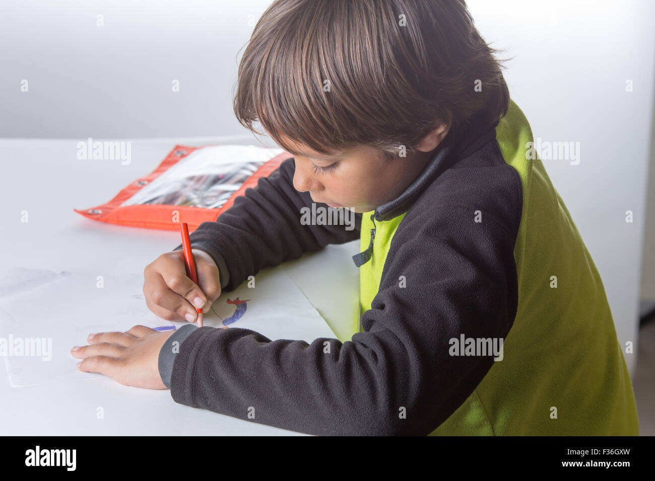 Young boy drawing picture for homeschool project Stock Photo - Alamy