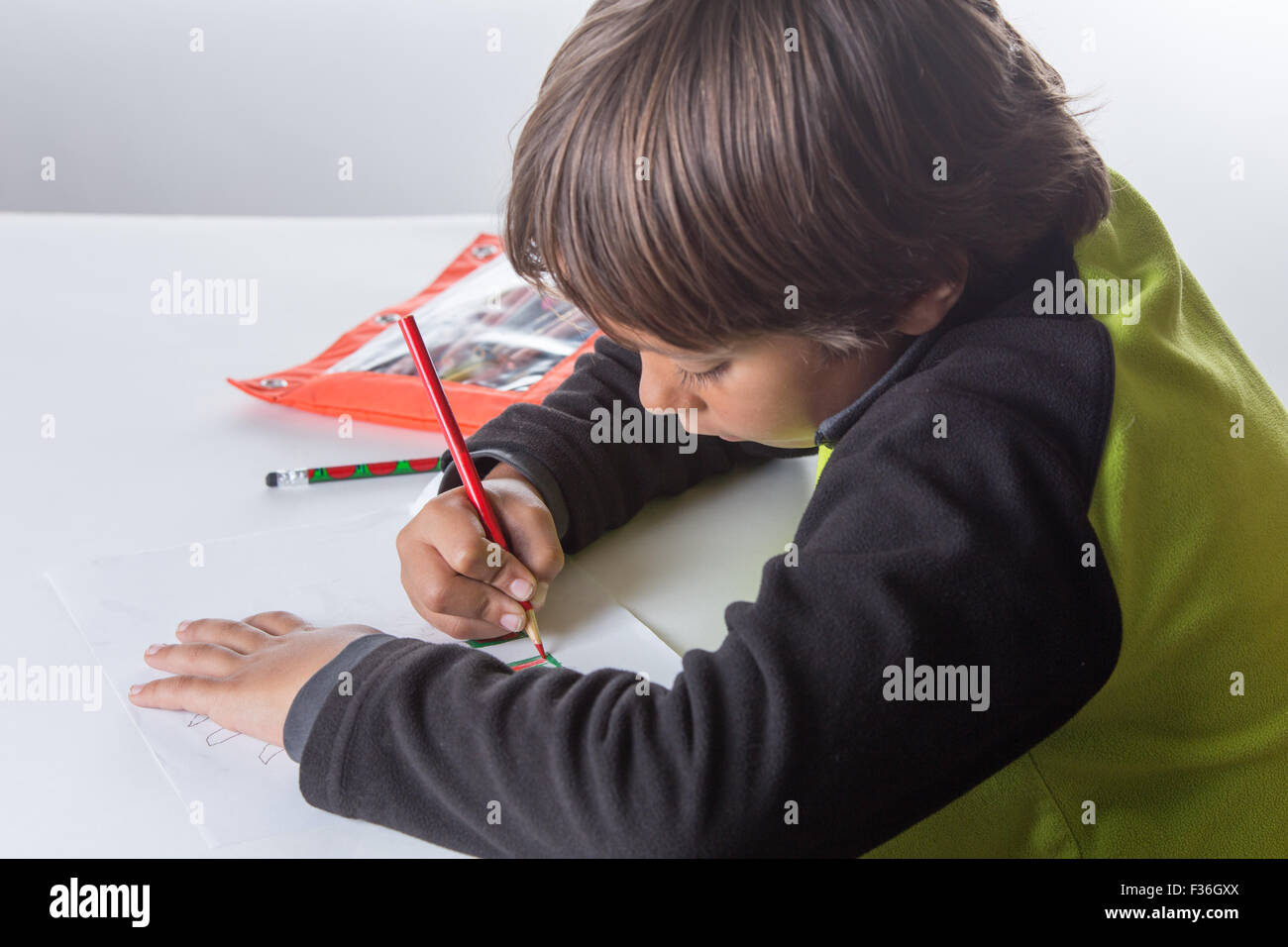Young boy drawing picture for homeschool project Stock Photo - Alamy