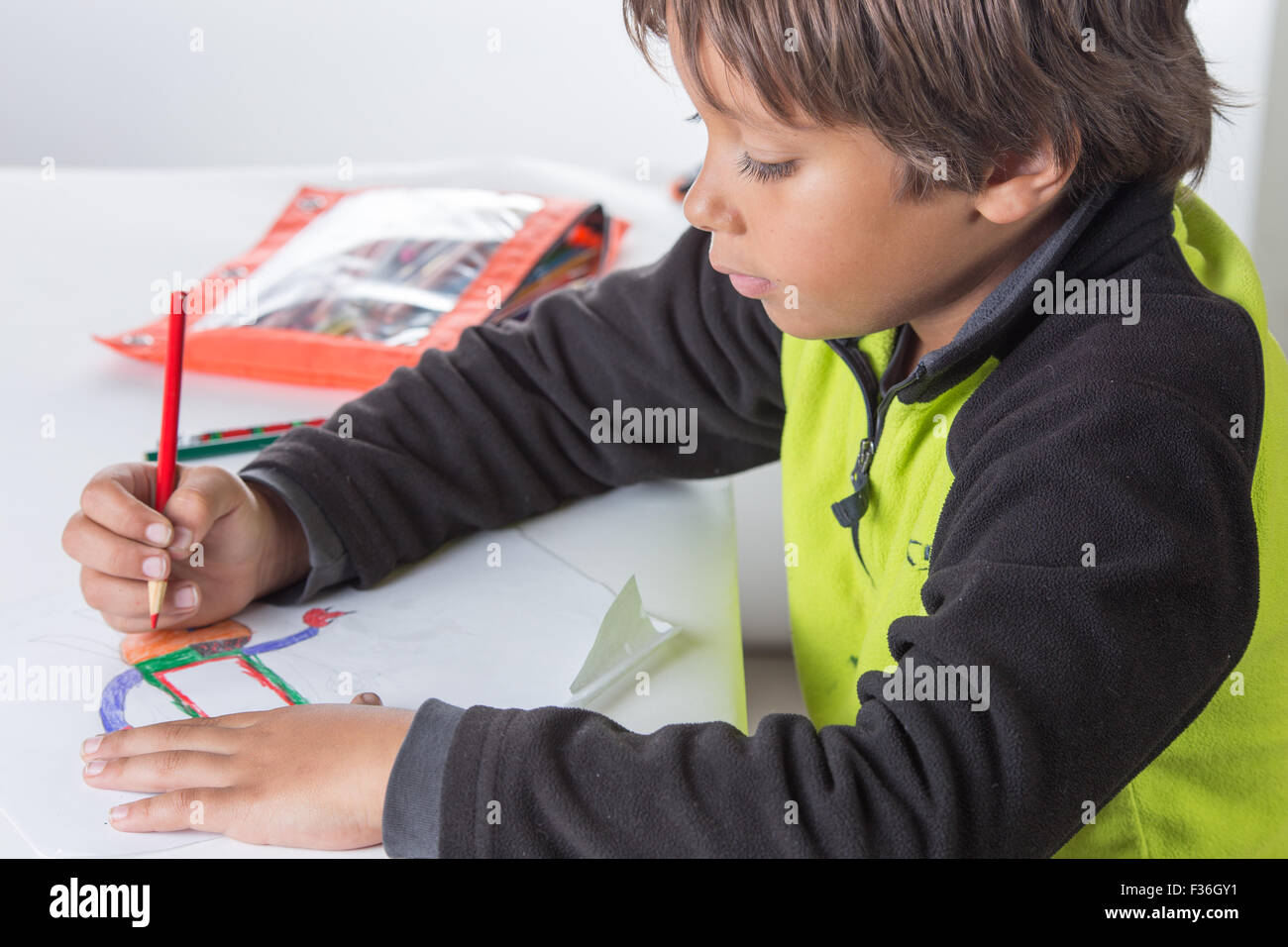 Young boy drawing picture for homeschool project Stock Photo - Alamy