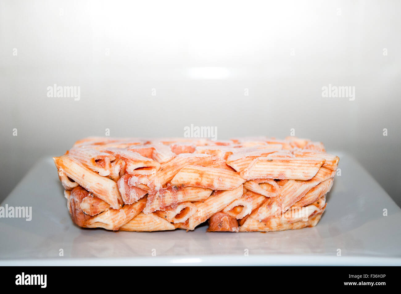 Frozen pasta meal ready for microwave cooking, still in the shape of ...
