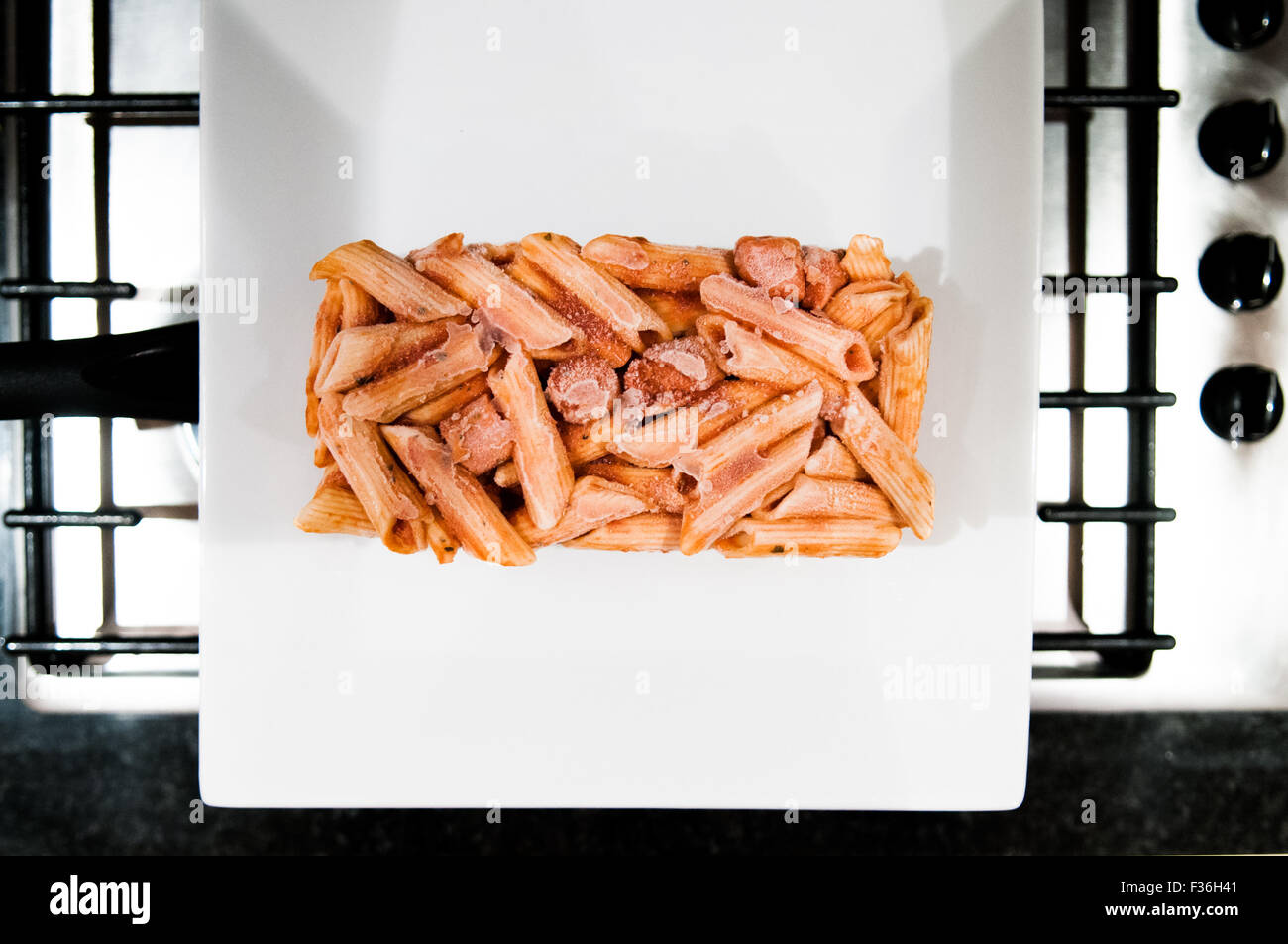 Frozen pasta meal ready for microwave cooking, still in the shape of ...