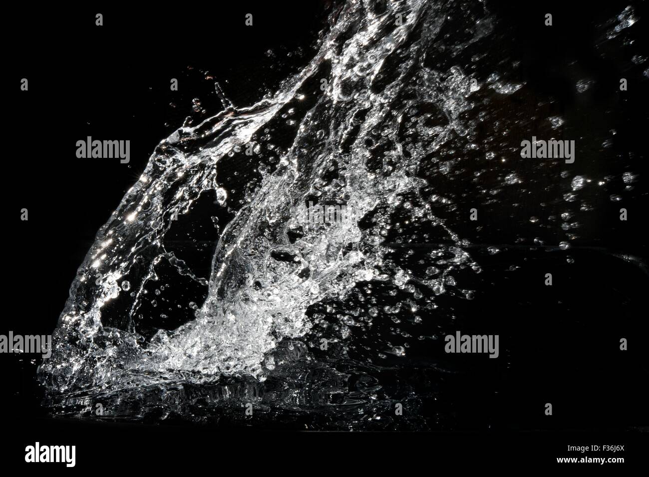 Stylish water splash. Isolated on black background Stock Photo - Alamy